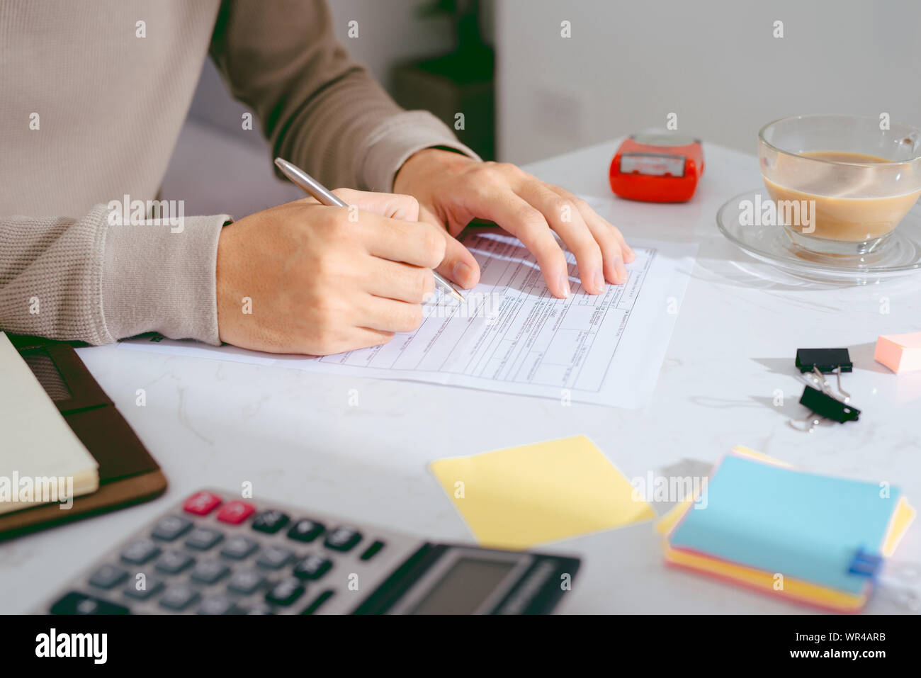 Rear view of business asian man calculate with analyze result summary ...