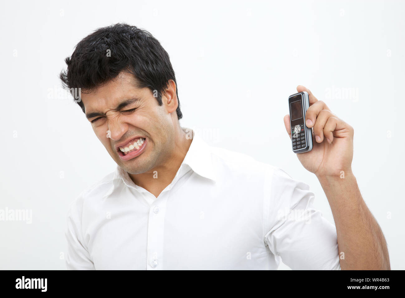 Young man holding mobile phone Stock Photo - Alamy