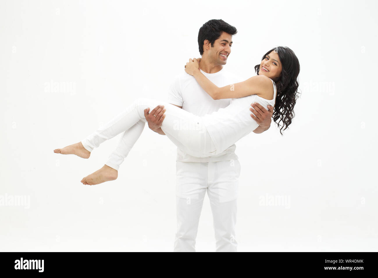 Young man carrying his girlfriend isolated on white background Stock ...