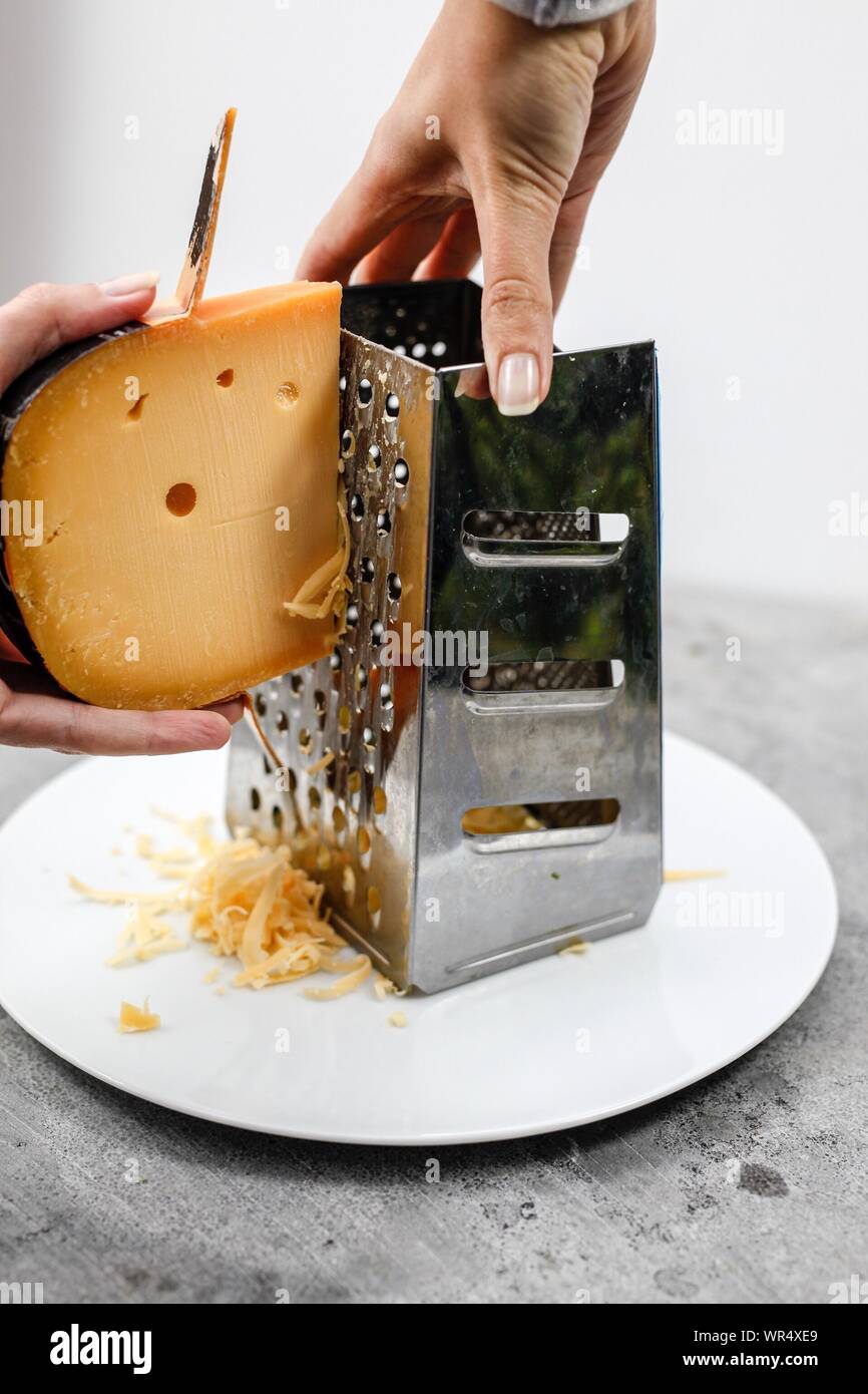 Grating cheese hi-res stock photography and images - Alamy
