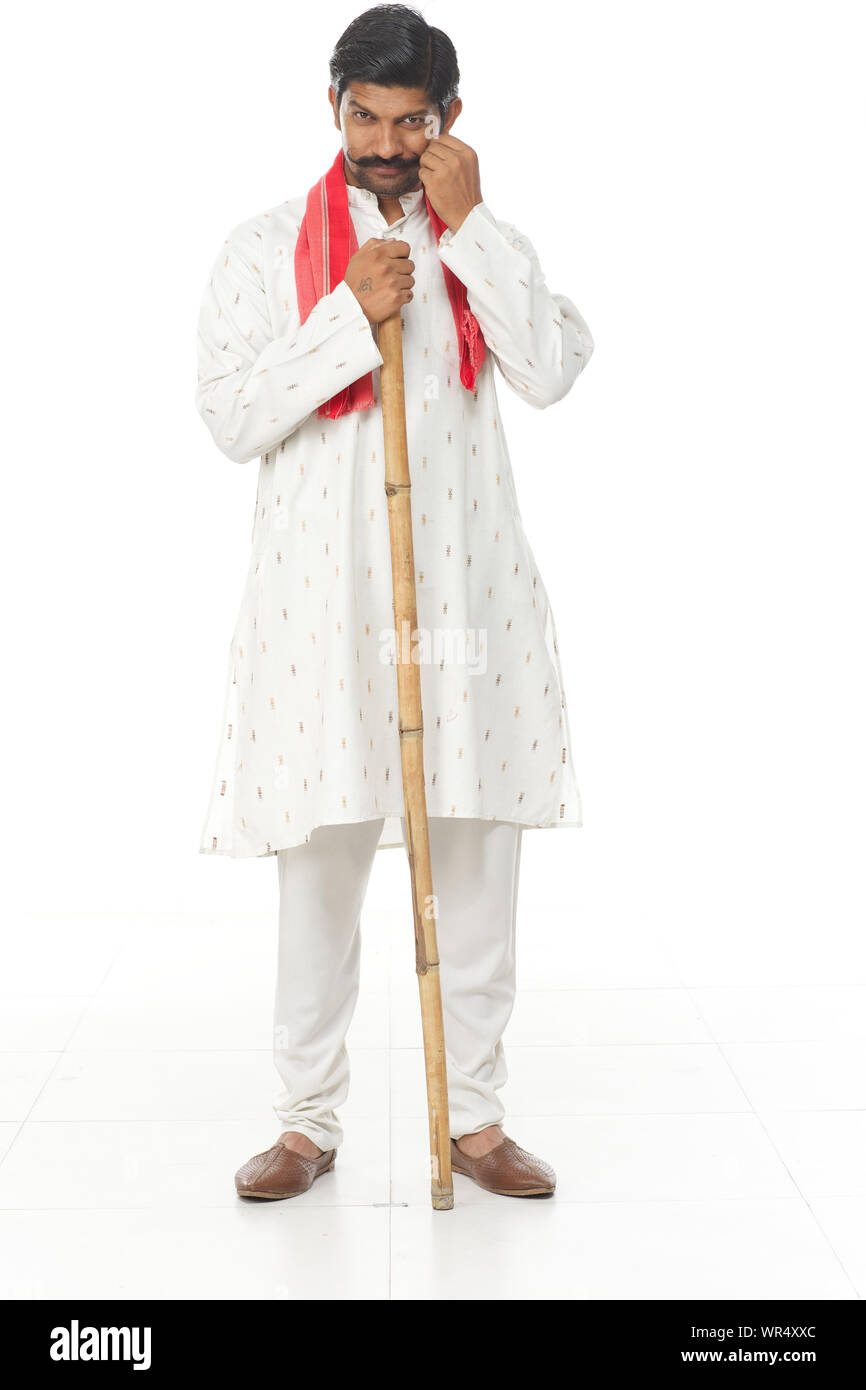 Rural man standing with his cane Stock Photo - Alamy