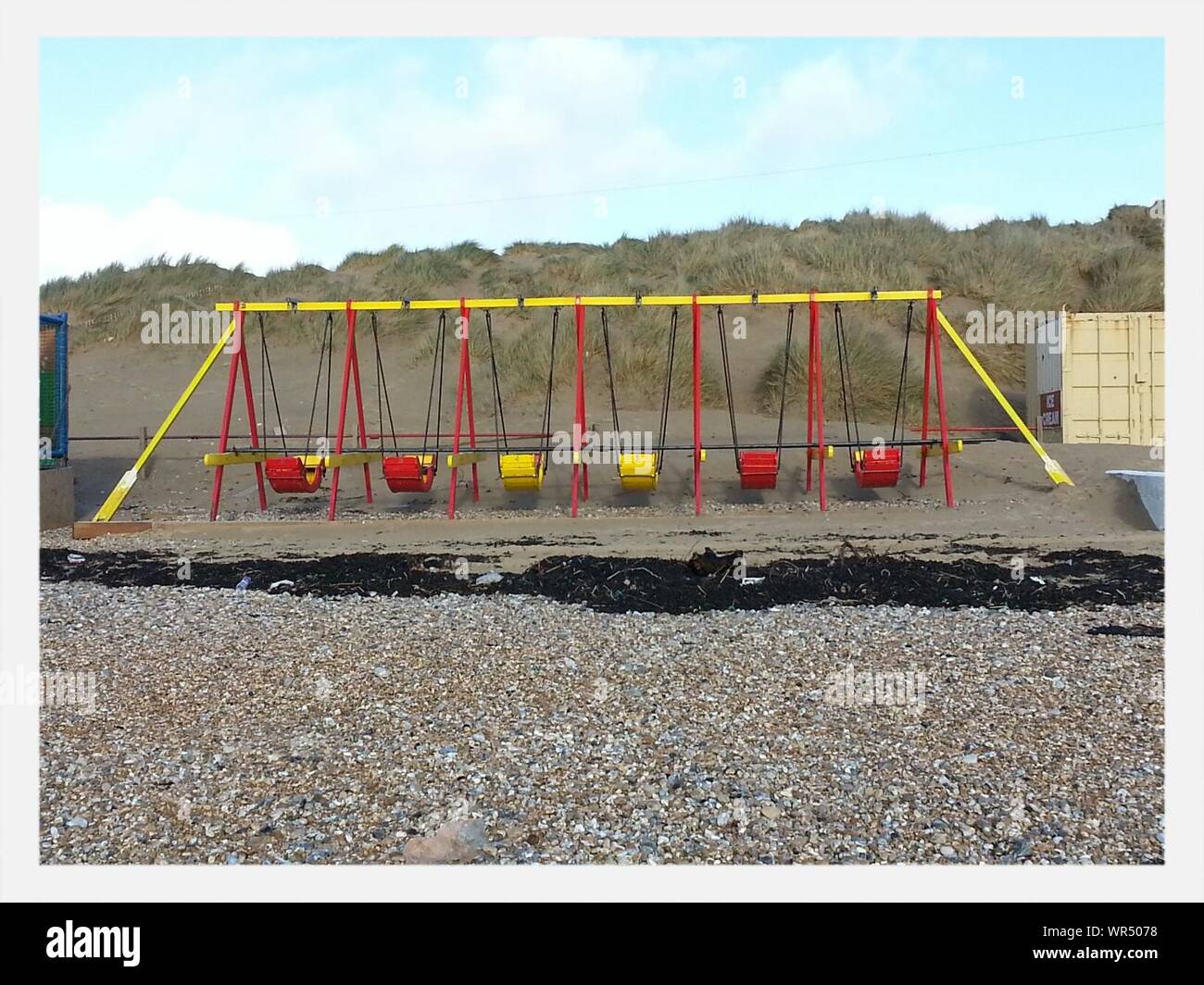 Red And Yellow Swings On Playground Stock Photo - Alamy