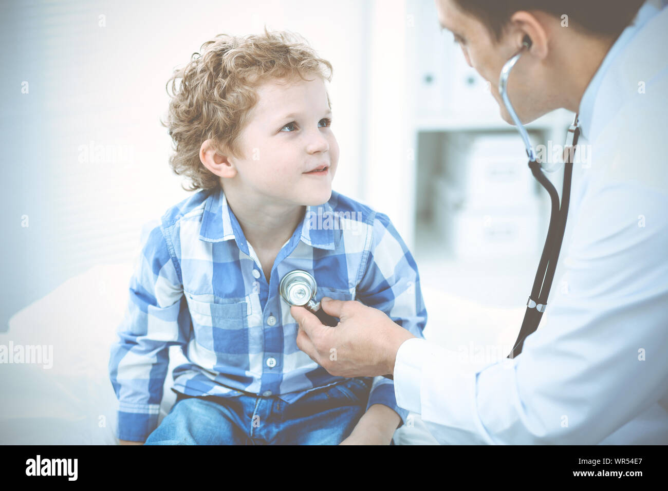 Doctor and patient child. Physician examining little boy. Regular ...