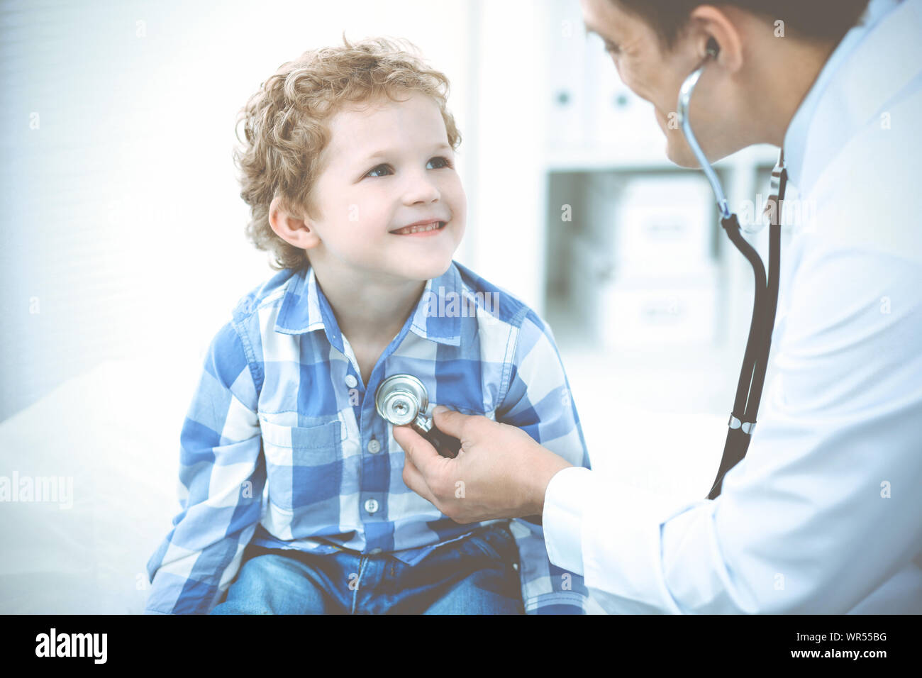 Doctor and patient child. Physician examining little boy. Regular ...