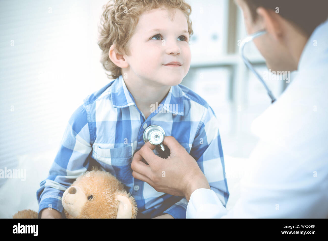 Doctor and patient child. Physician examining little boy. Regular ...