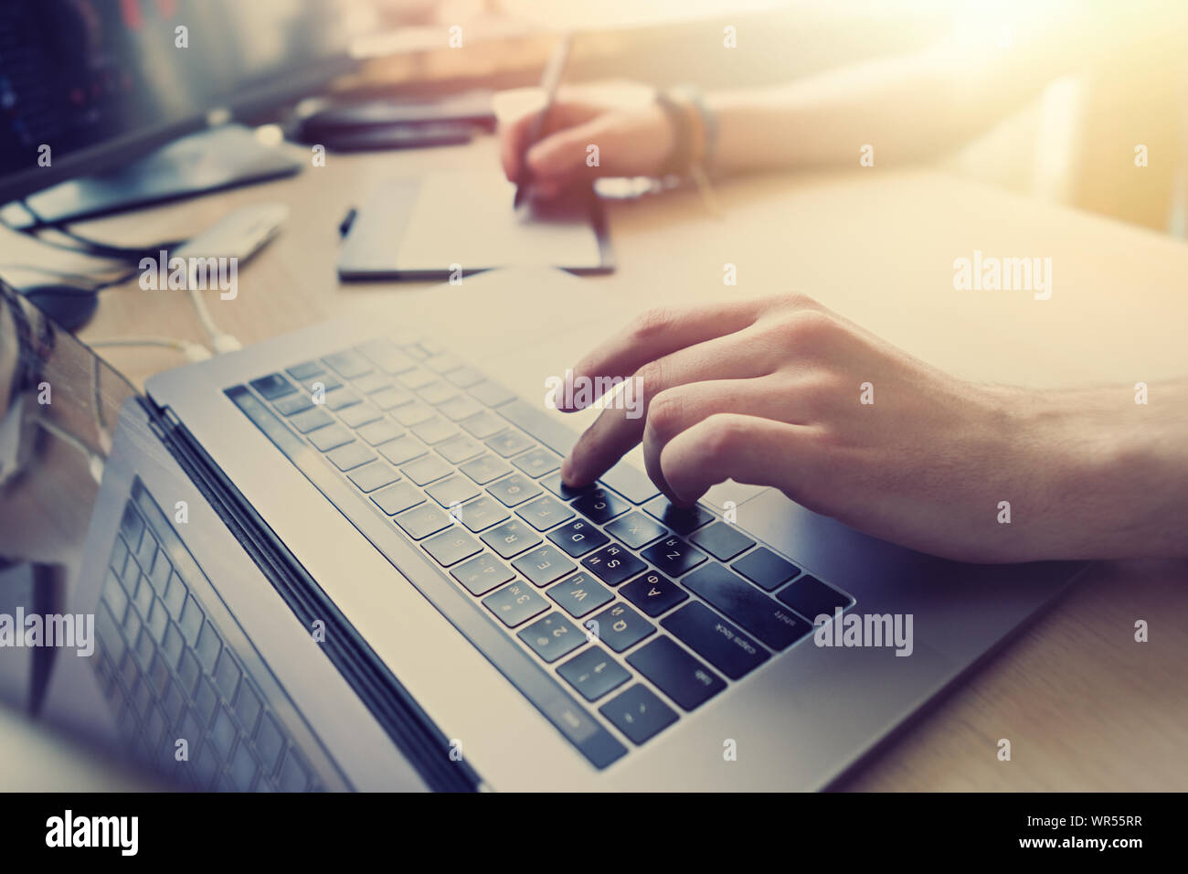 Professional graphic editor retouching images with stylus pen in hand ...