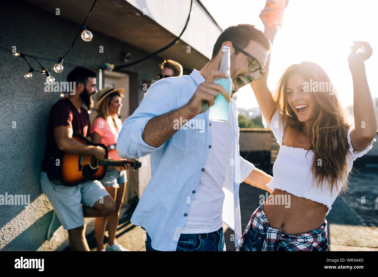 Happy couple having fun time at party Stock Photo - Alamy