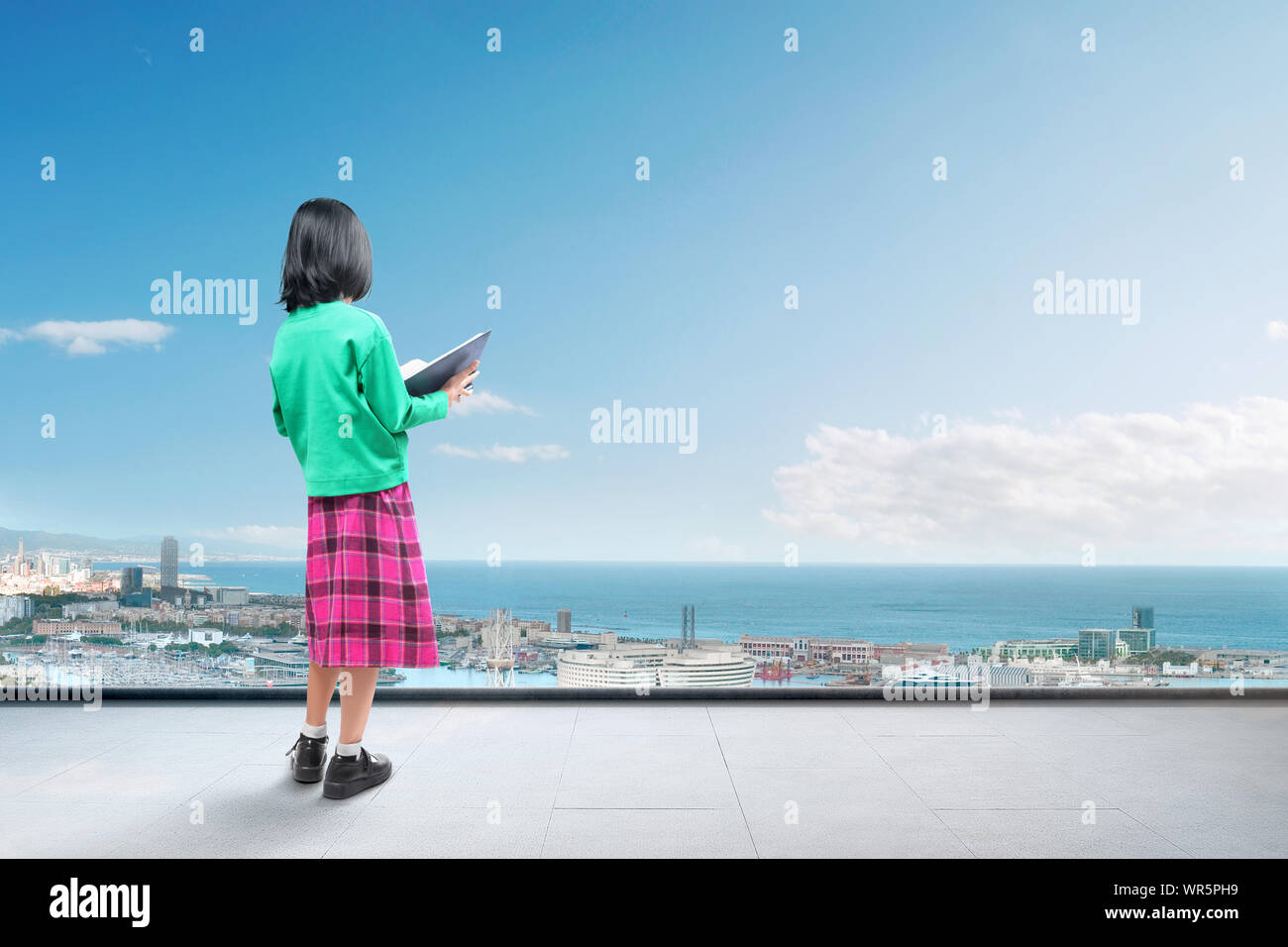 Rear view of Asian cute girl standing while reading the book on the ...