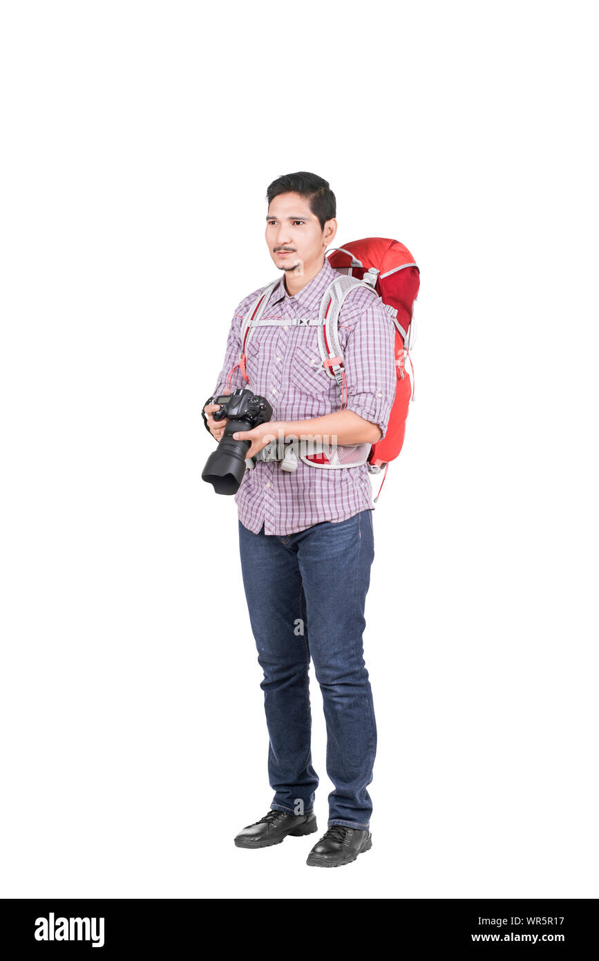 Asian man with a backpack holding a camera to take pictures isolated ...