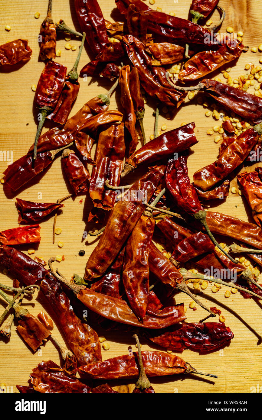 Whole dried chilli peppers with seeds lying in sunlight beam Stock ...