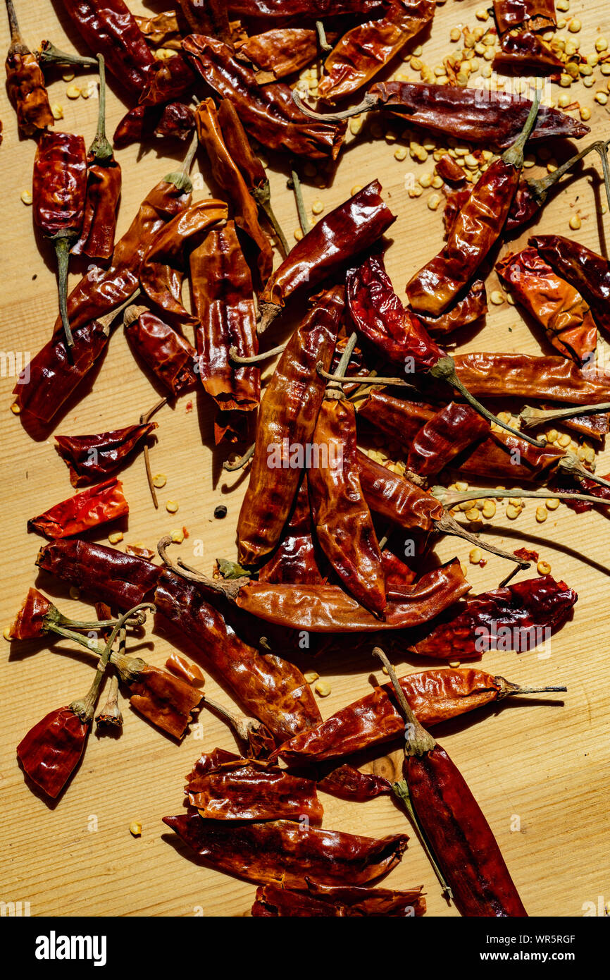 Whole dried chilli peppers with seeds lying in sunlight beam Stock ...