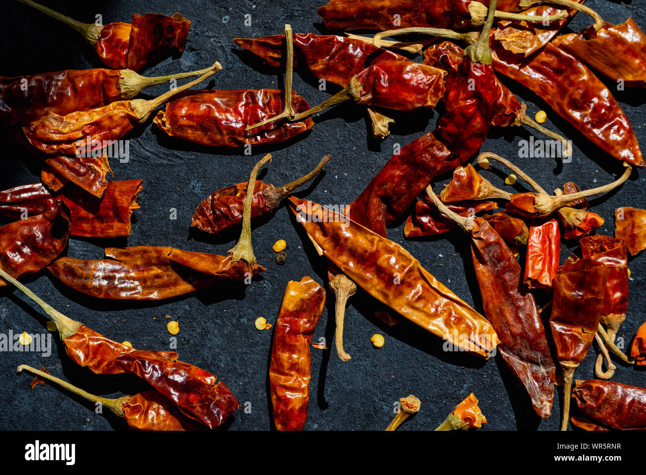 Whole dried chilli peppers with seeds lying in sunlight beam Stock ...