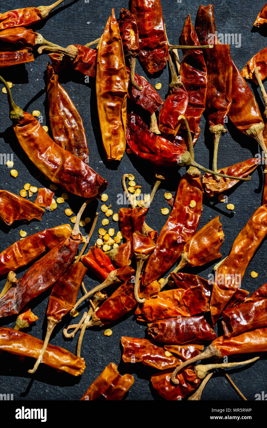 Whole dried chilli peppers with seeds lying in sunlight beam Stock ...