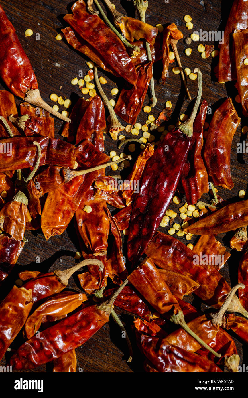 Whole dried chilli peppers with seeds lying in sunlight beam Stock ...
