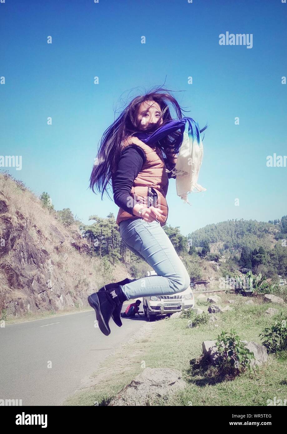Woman jumping rock formation hi-res stock photography and images - Alamy