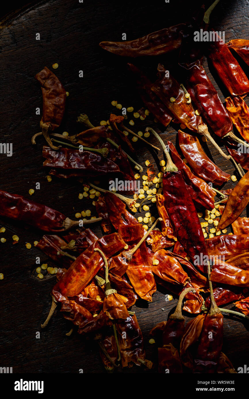 Whole dried chilli peppers with seeds lying in sunlight beam Stock ...