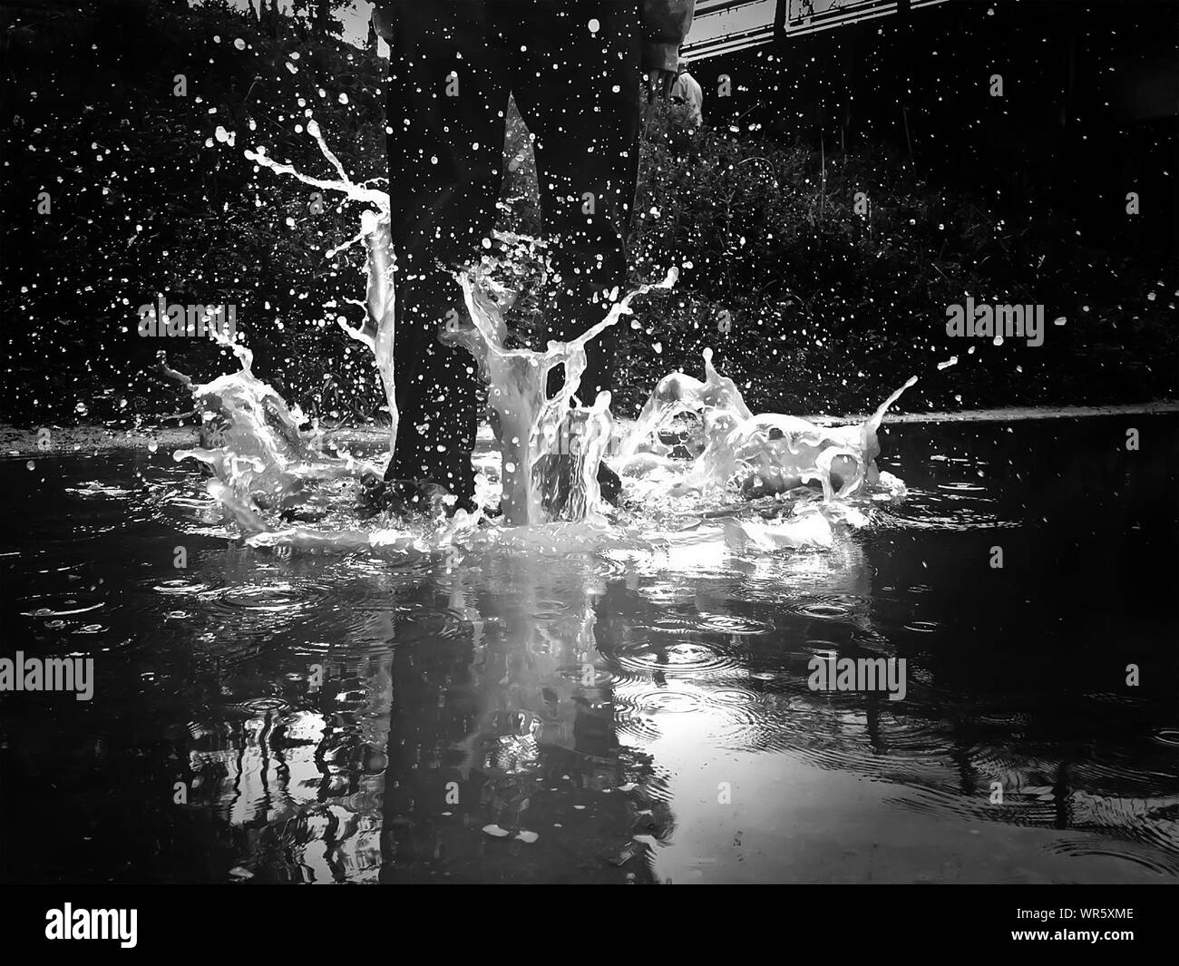 Man standing water leg Black and White Stock Photos & Images - Alamy
