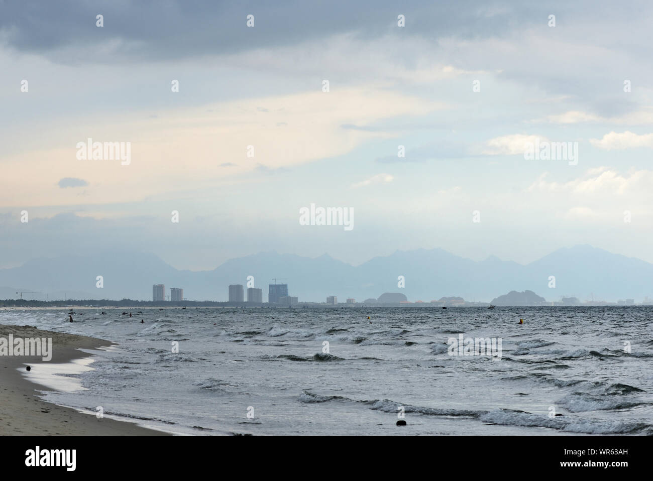 Seascape on the Vietnam coast with a view of the mountains, boats and ...