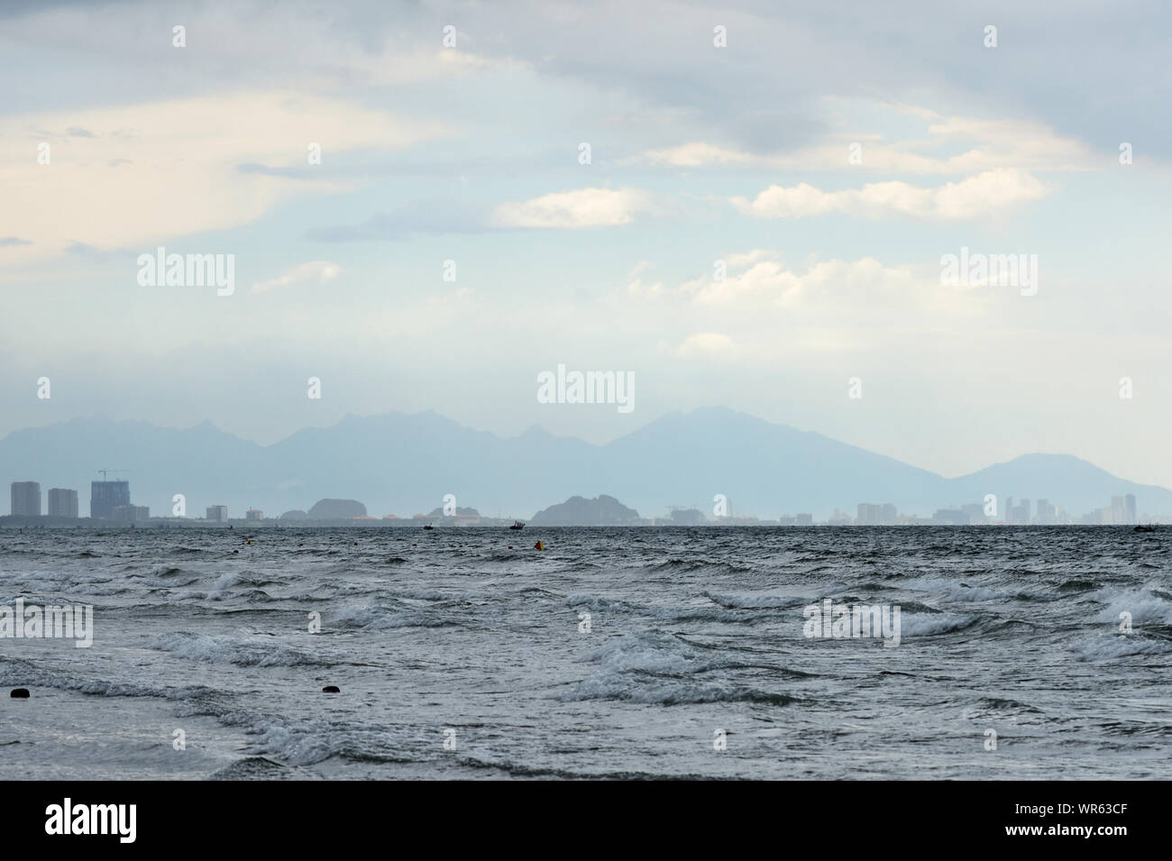 Seascape on the Vietnam coast with a view of the mountains, boats and ...