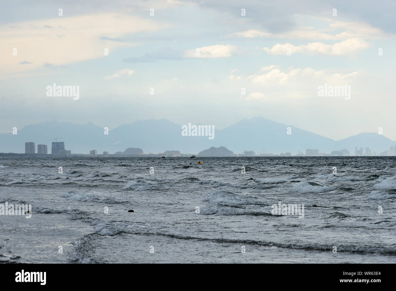 Seascape on the Vietnam coast with a view of the mountains, boats and ...