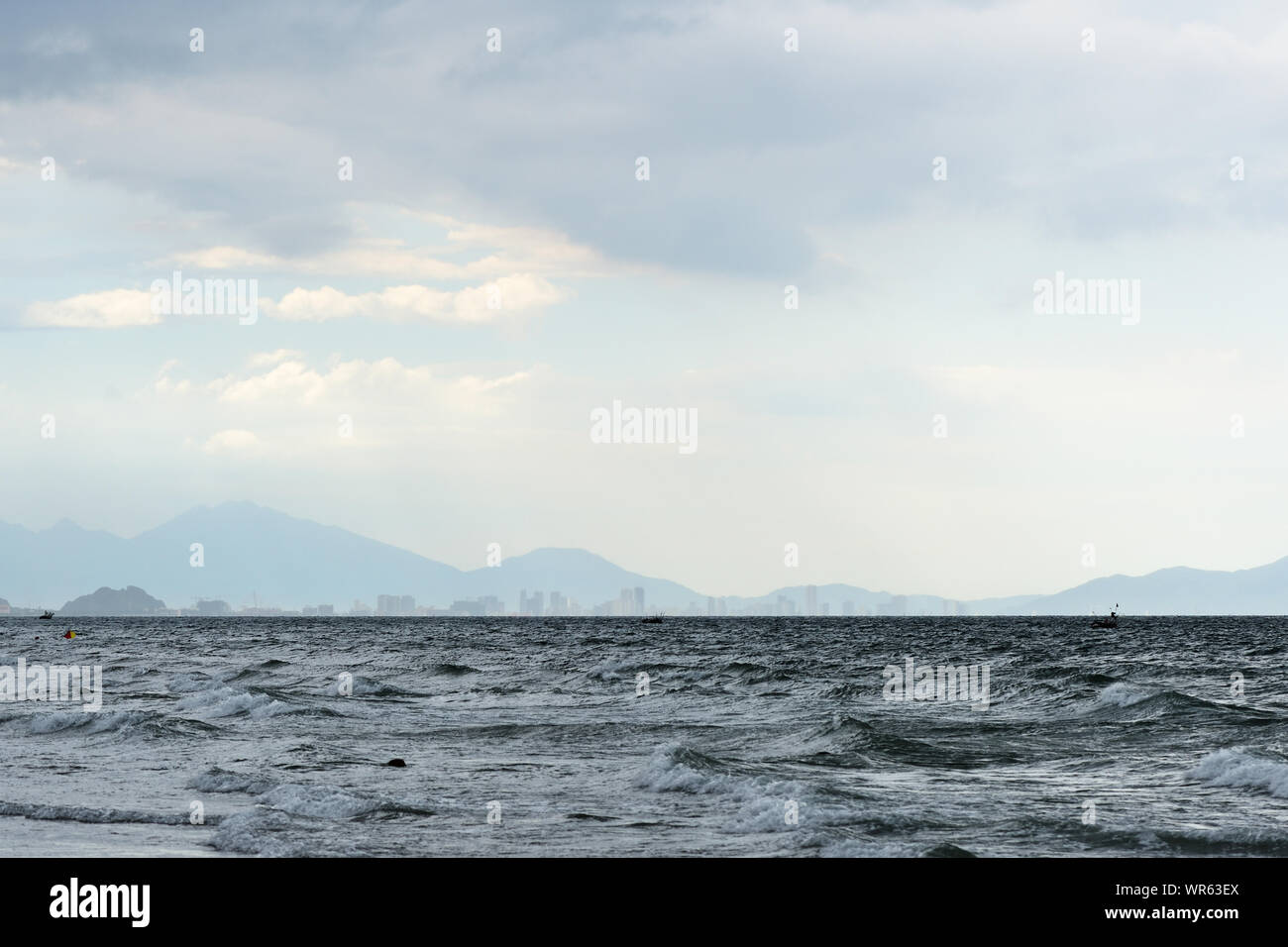 Seascape on the Vietnam coast with a view of the mountains, boats and ...