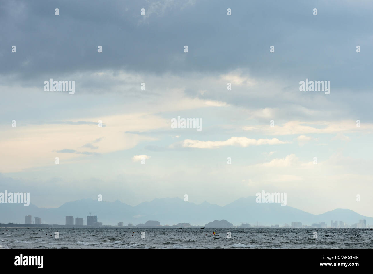 Seascape on the Vietnam coast with a view of the mountains, boats and ...
