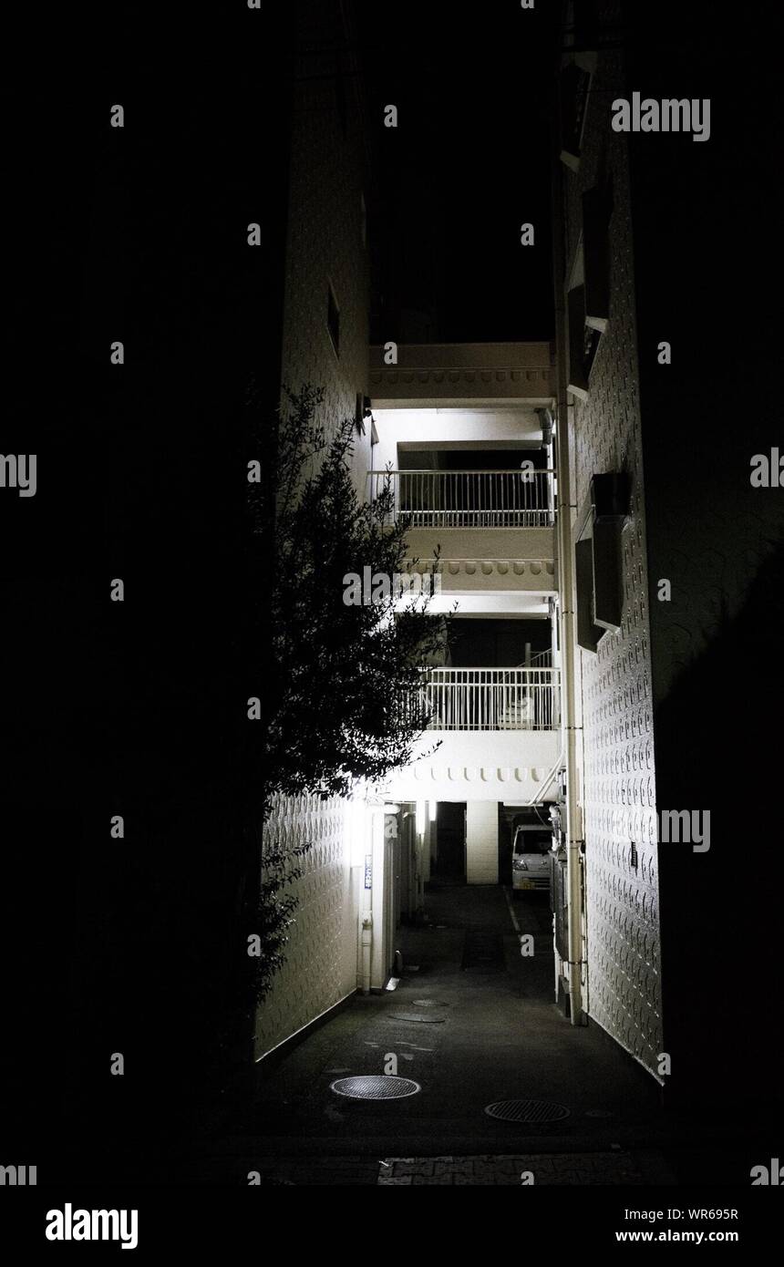 Alley Amidst Buildings At Night Stock Photo - Alamy
