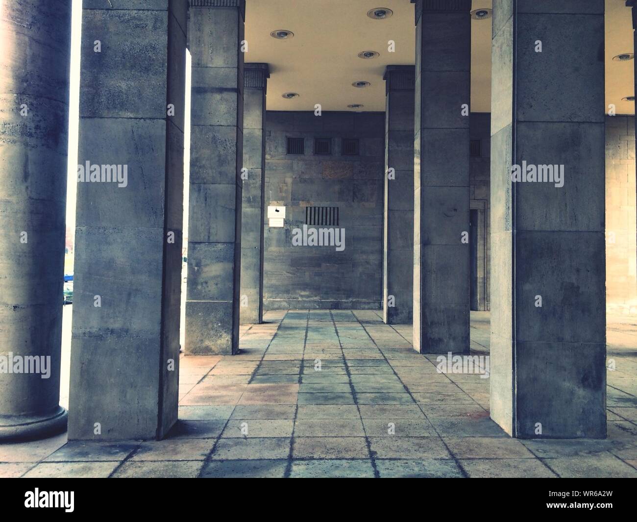 Corridor With Tiled Floor And Pillars Stock Photo - Alamy