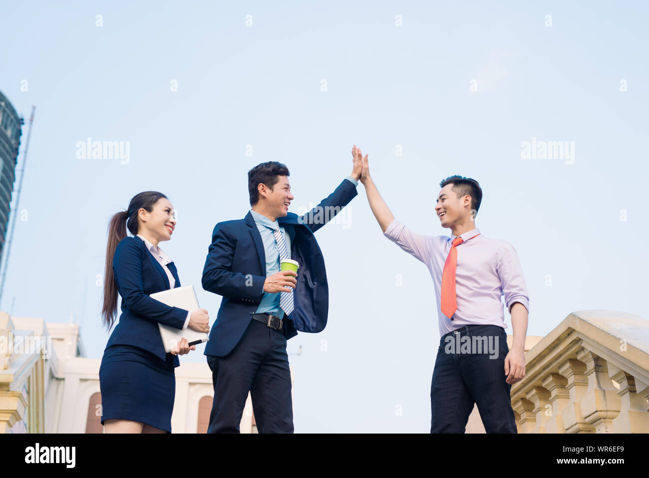 Happy Businessmen And Businesswoman Celebrate Success In Project Task
