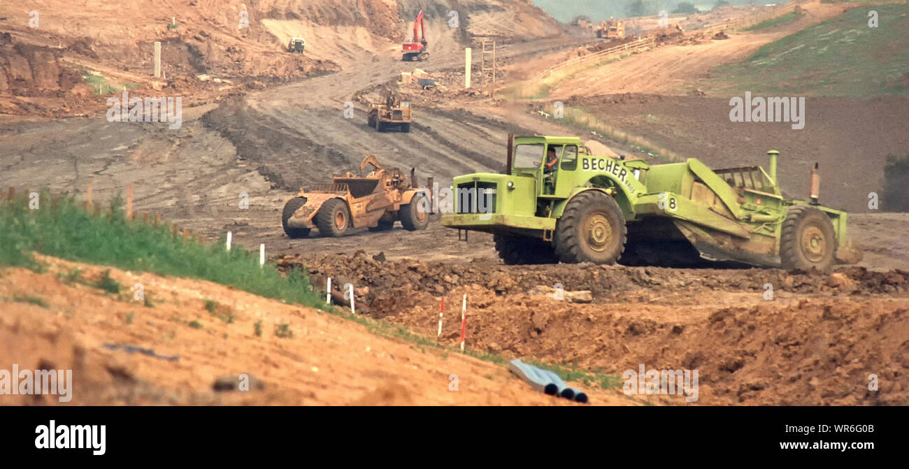 Large motor scraper earth moving machine scraping away soil to form ...