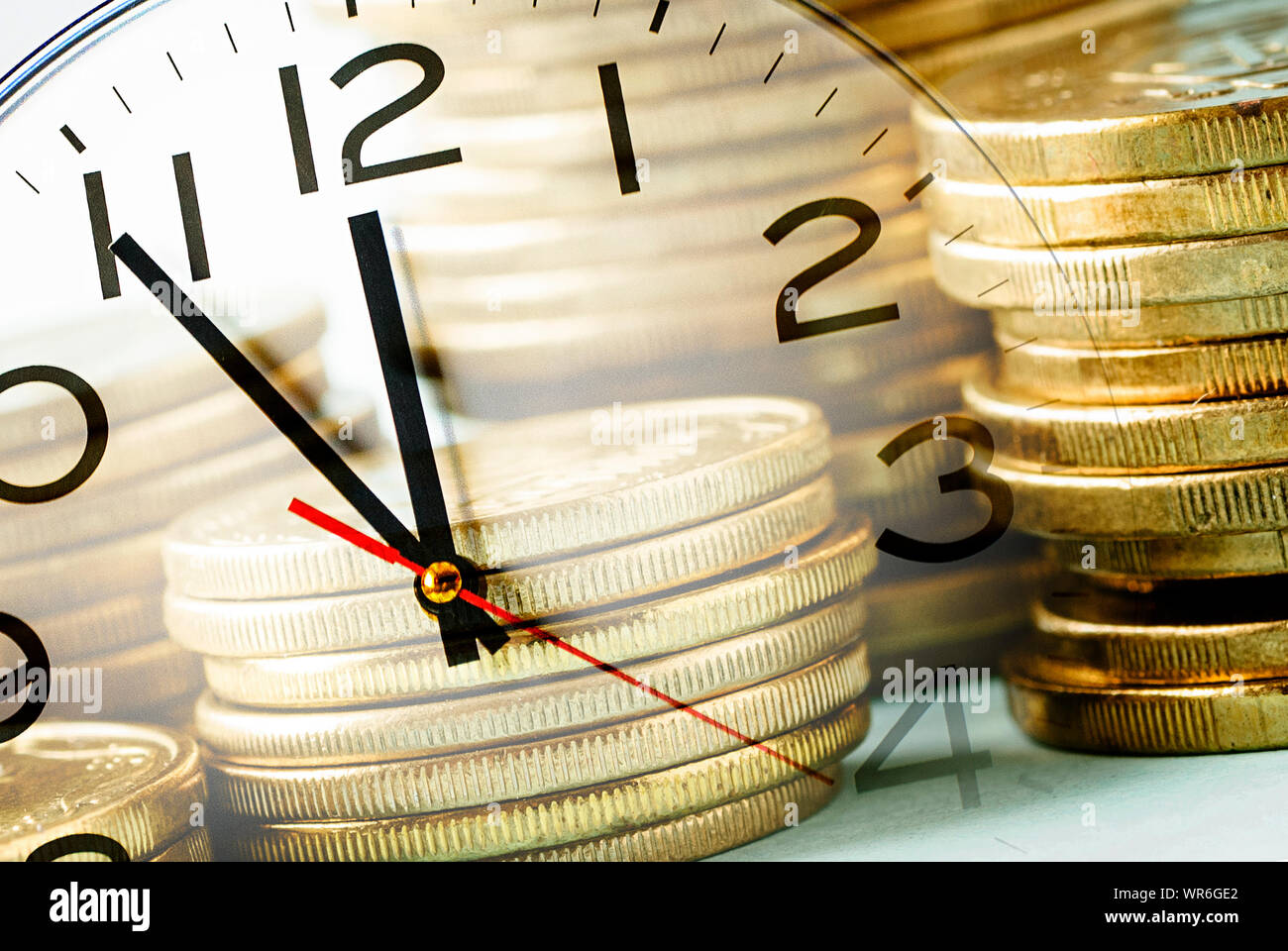 Composite image of stacked gold coins and a clock in a concept of time ...