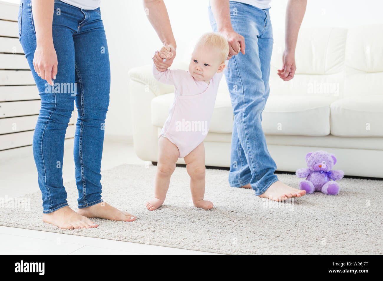 little girl first steps with the help of mom Stock Photo - Alamy