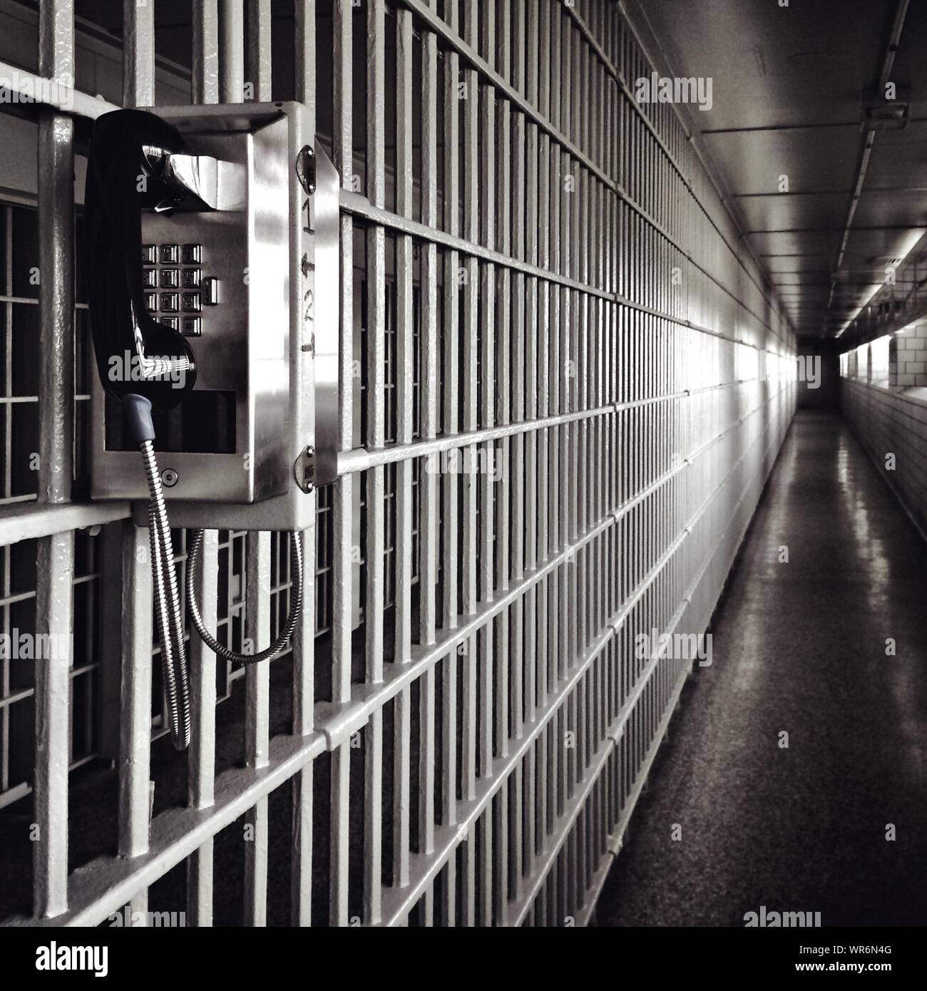 Telephone On Railed Wall Along Narrow Pathway Stock Photo - Alamy