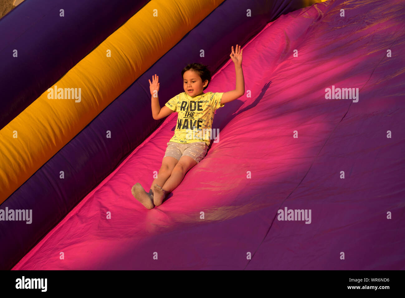 Young boy plays on a big slider Stock Photo - Alamy