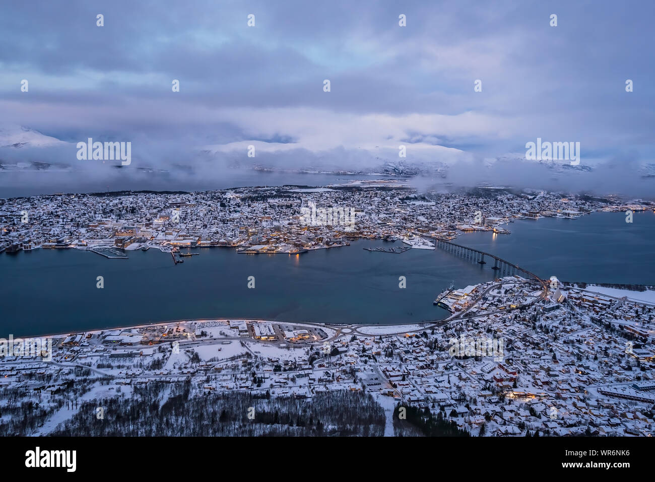 Aerial view to the city of Tromso in winter from the mountain ledge Storsteinen, 421 m above sea ...