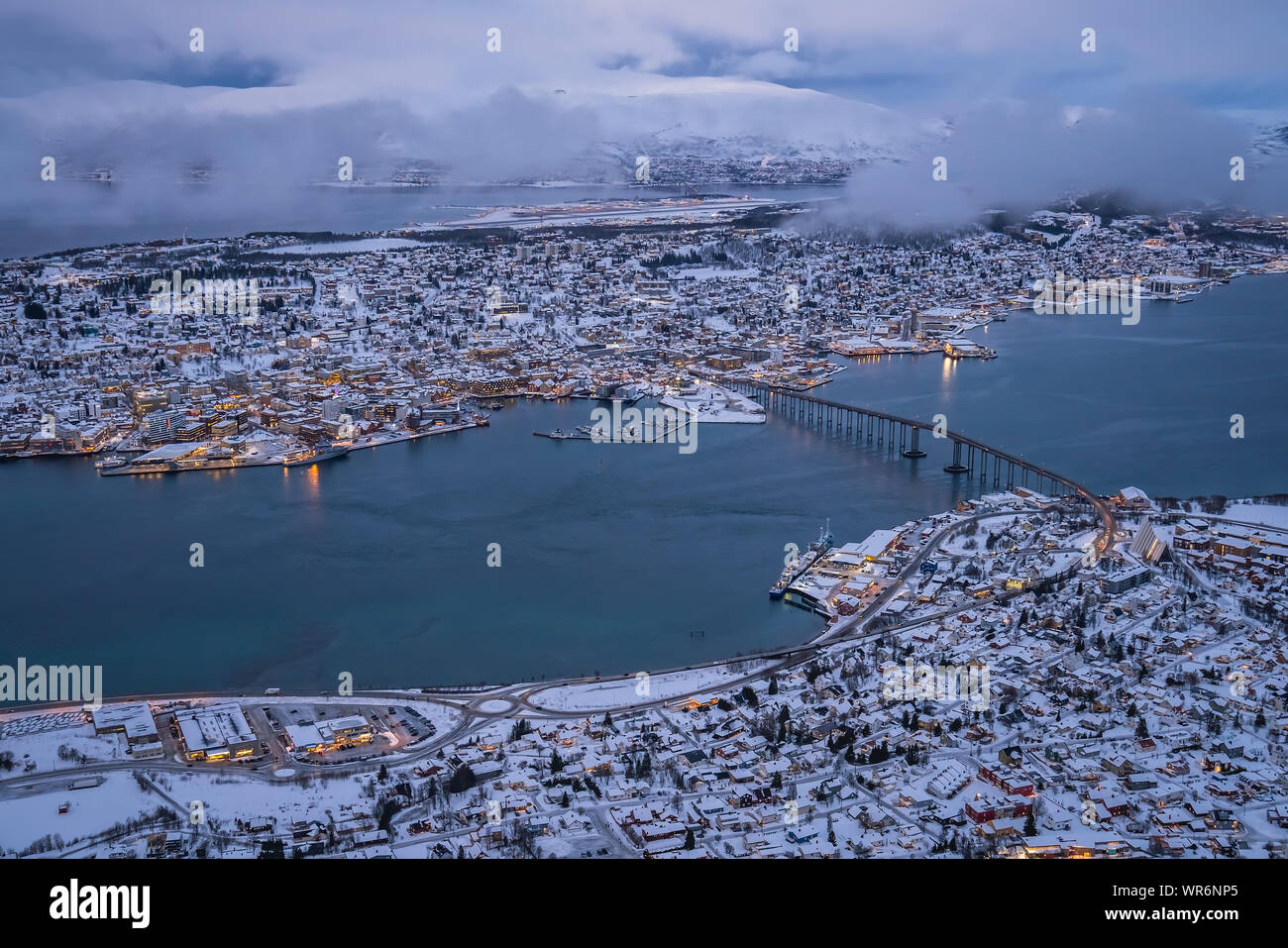 Aerial view to the city of Tromso in winter from the mountain ledge Storsteinen, 421 m above sea ...