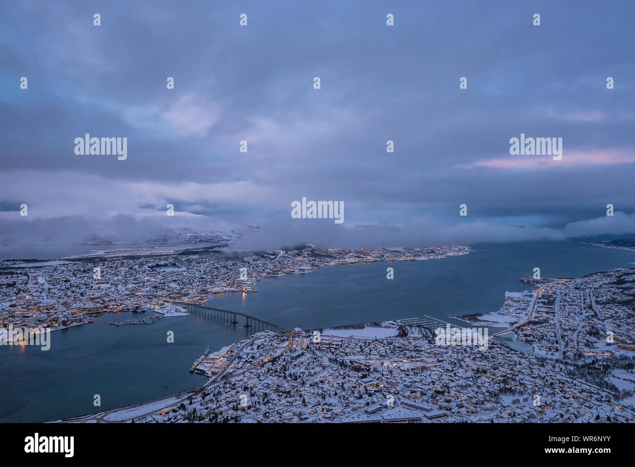 Aerial view to the city of Tromso in winter from the mountain ledge Storsteinen, 421 m above sea ...