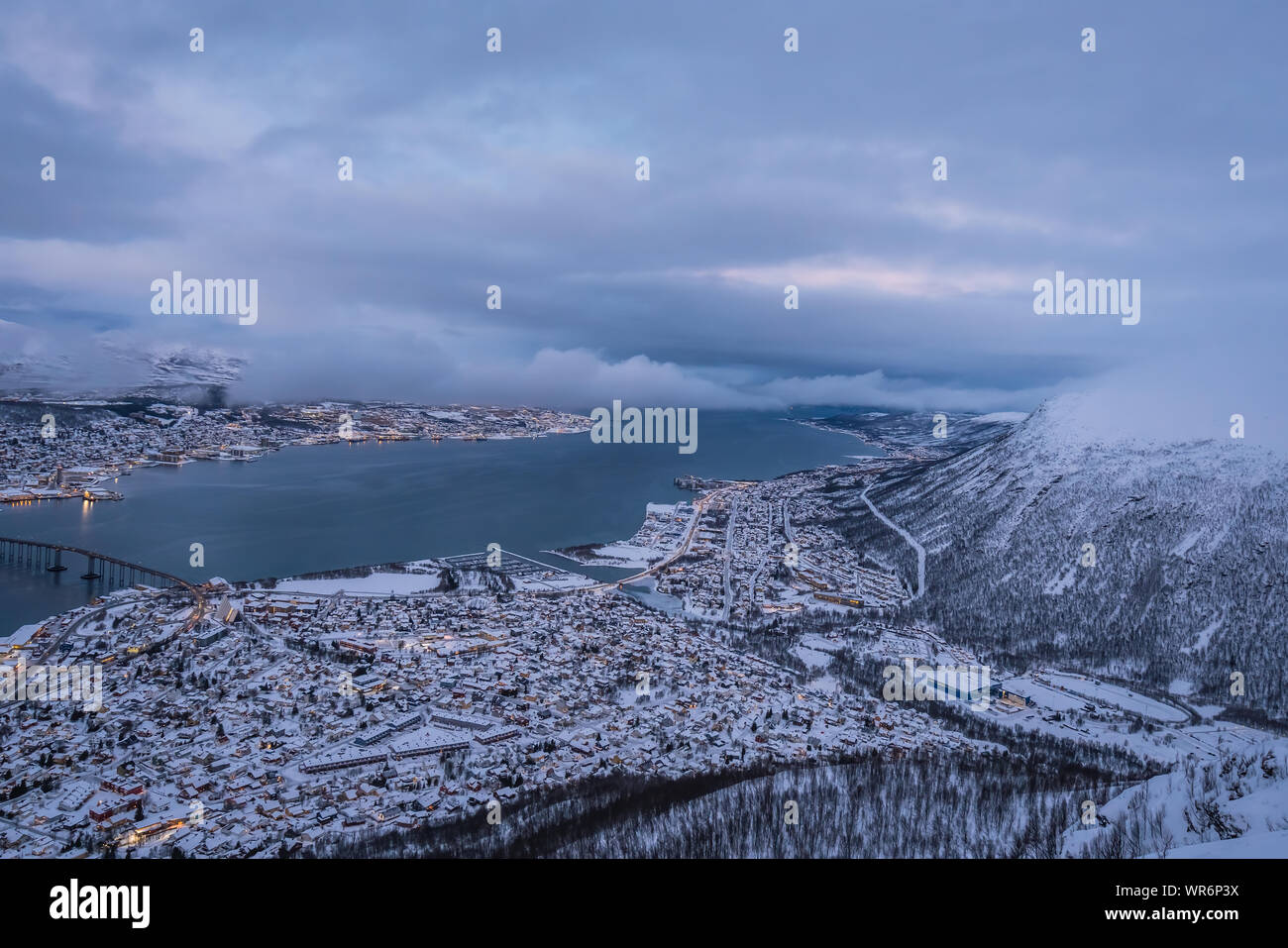 Aerial view to the city of Tromso in winter from the mountain ledge Storsteinen, 421 m above sea ...