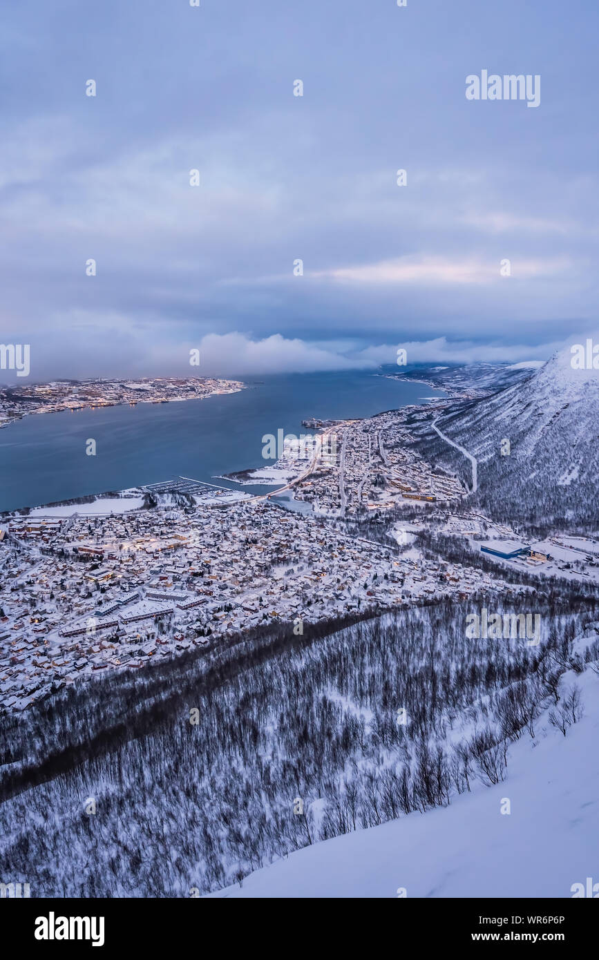Aerial view to the city of Tromso in winter from the mountain ledge ...