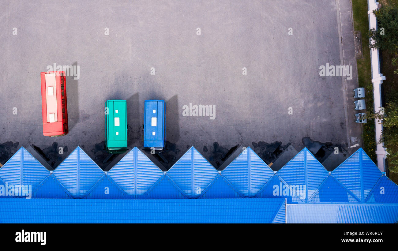 three colorful buses are at the bus station top view aerial photography ...