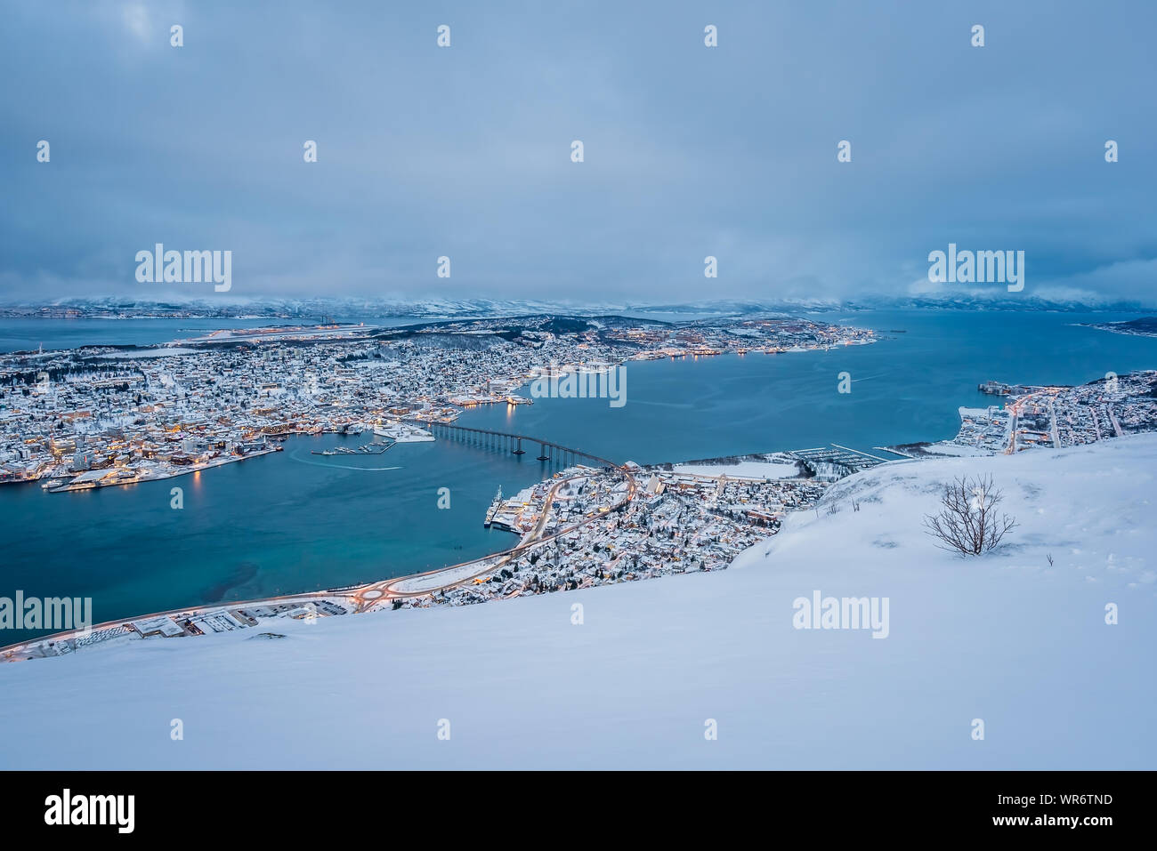 Aerial view to the city of Tromso in winter from the mountain ledge ...