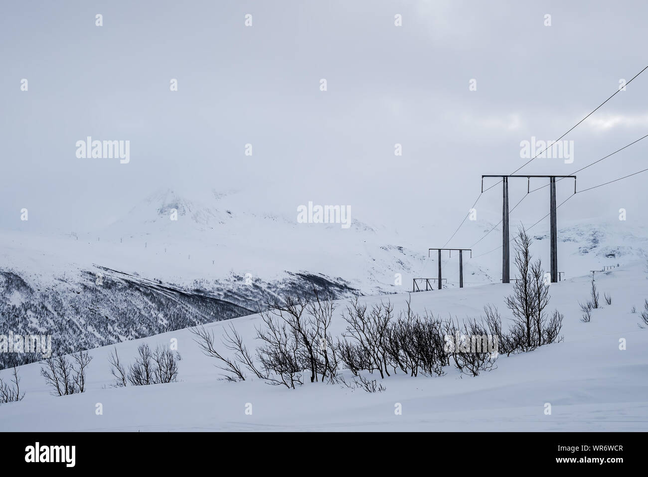 Electric poles in the snow among the wonderful winter scenery, Norway ...