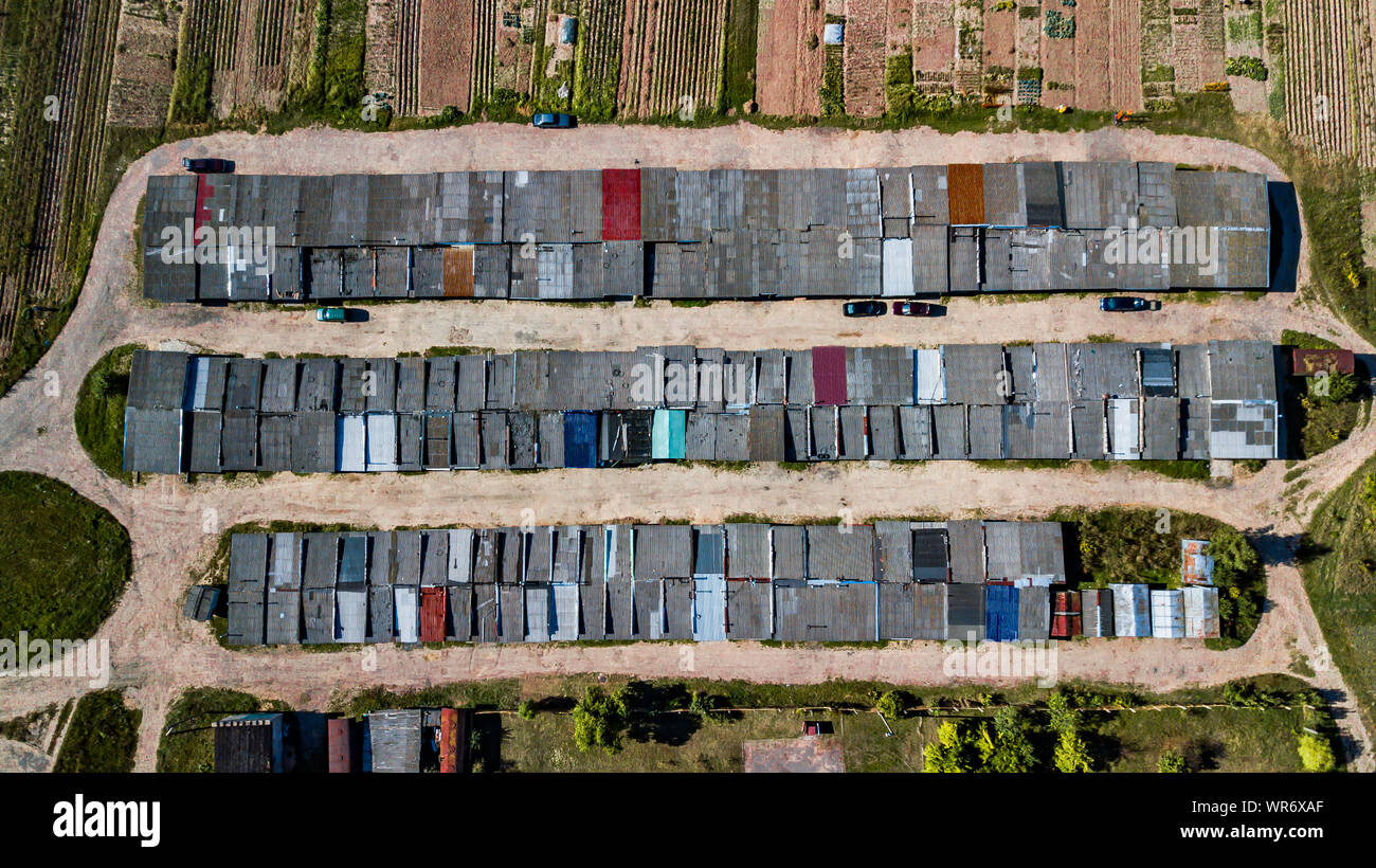 Aerial view of apartment garage with full of covered parking, cars and ...