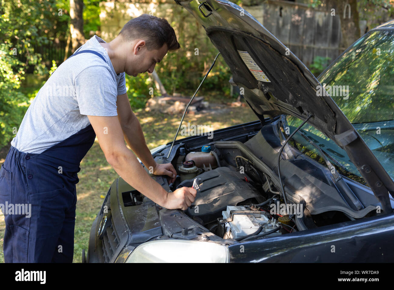 Picture of a mechanic checking broken car Stock Photo - Alamy