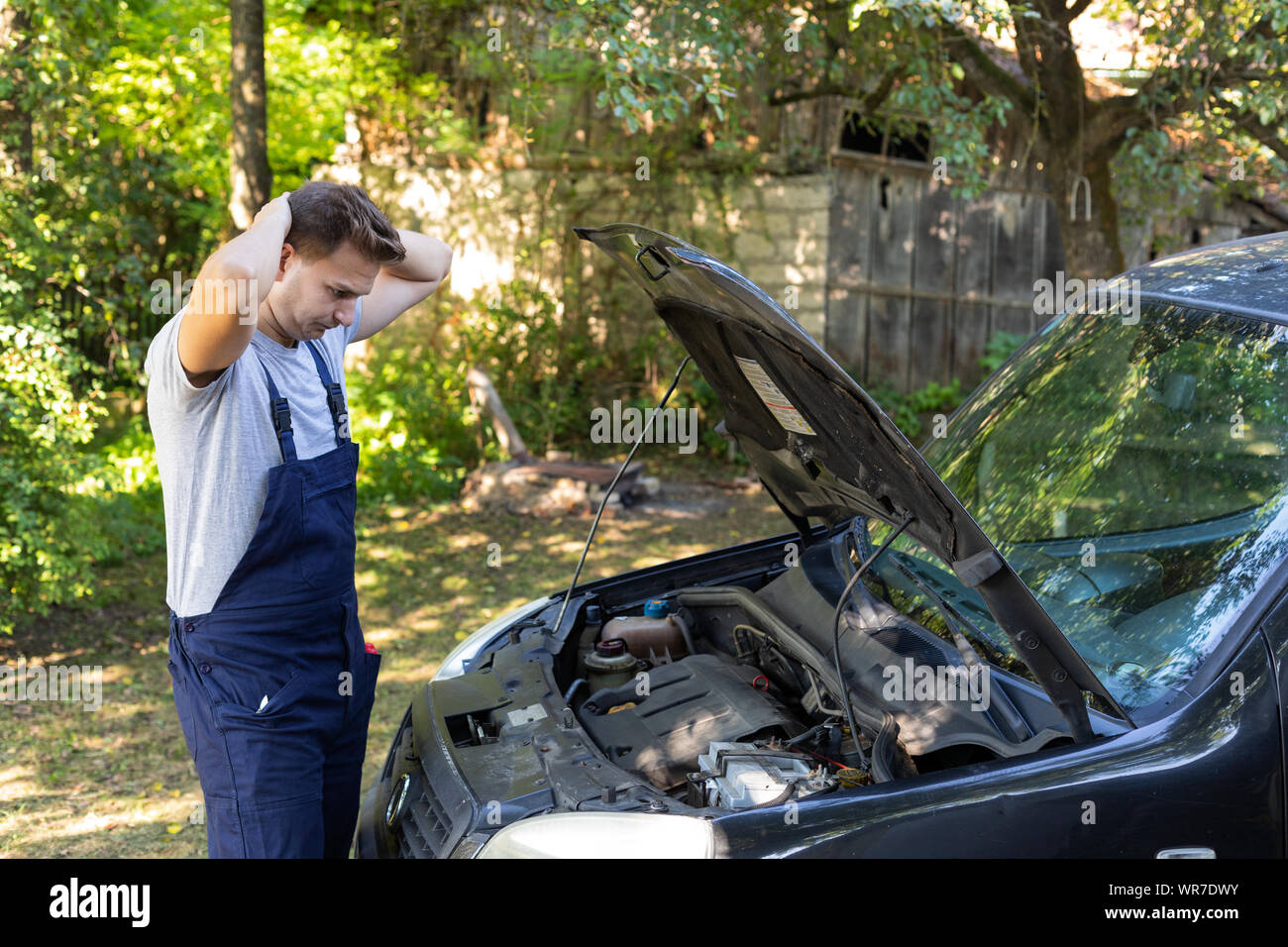 Picture of a mechanic checking broken car Stock Photo - Alamy