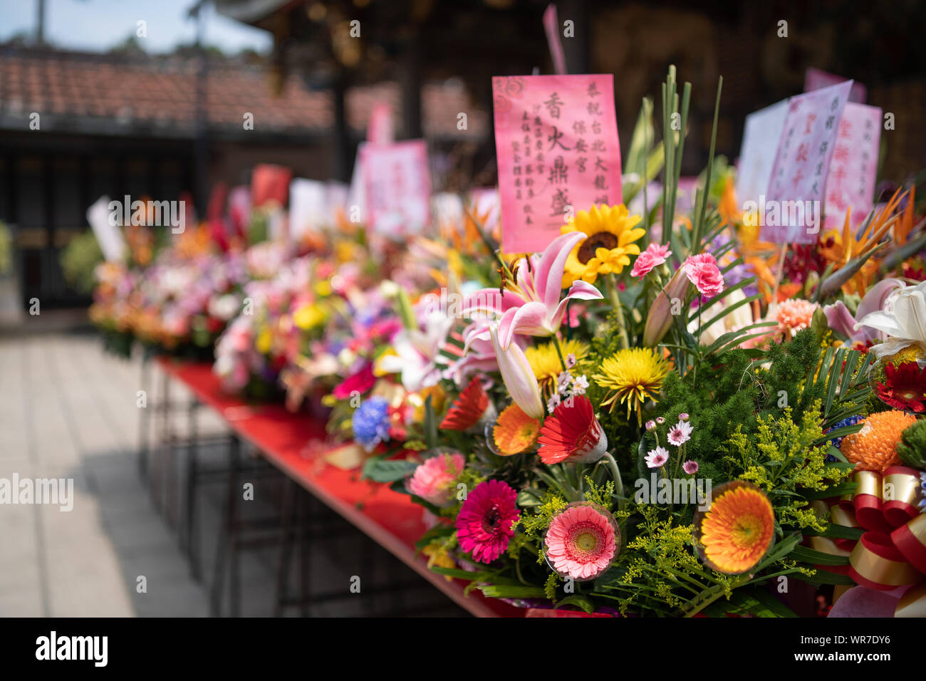 Taiwan: Offerings of colorful flowers at taoist temple in Taipei Stock ...