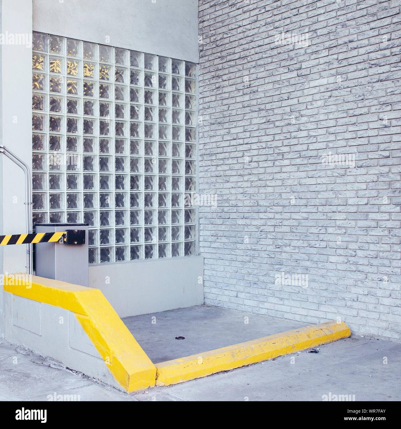 Frosted Glass By Brick Wall Against Barrier Stock Photo - Alamy