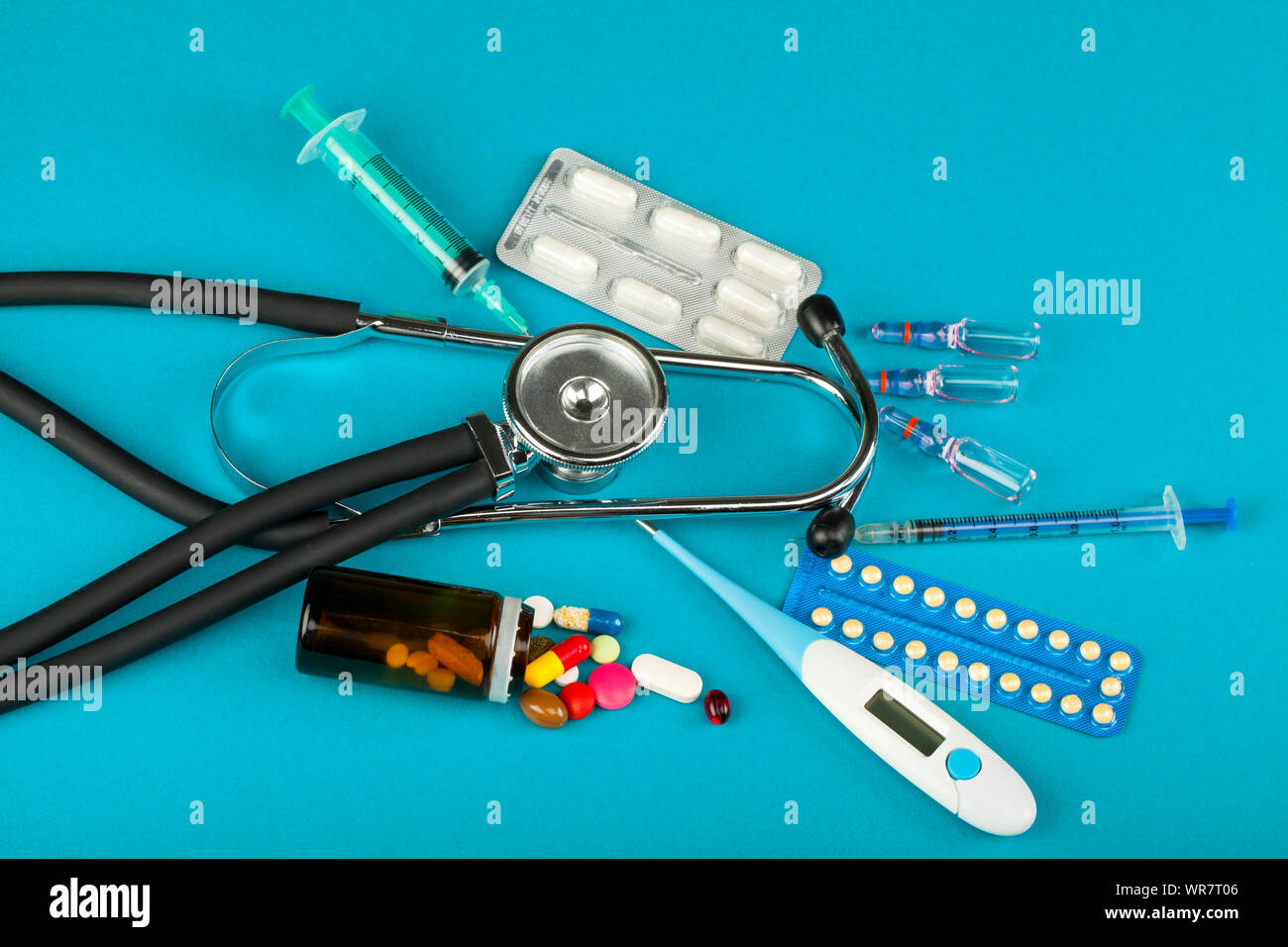 Picture of medical supplies: stethoscope, bottle of medication ...