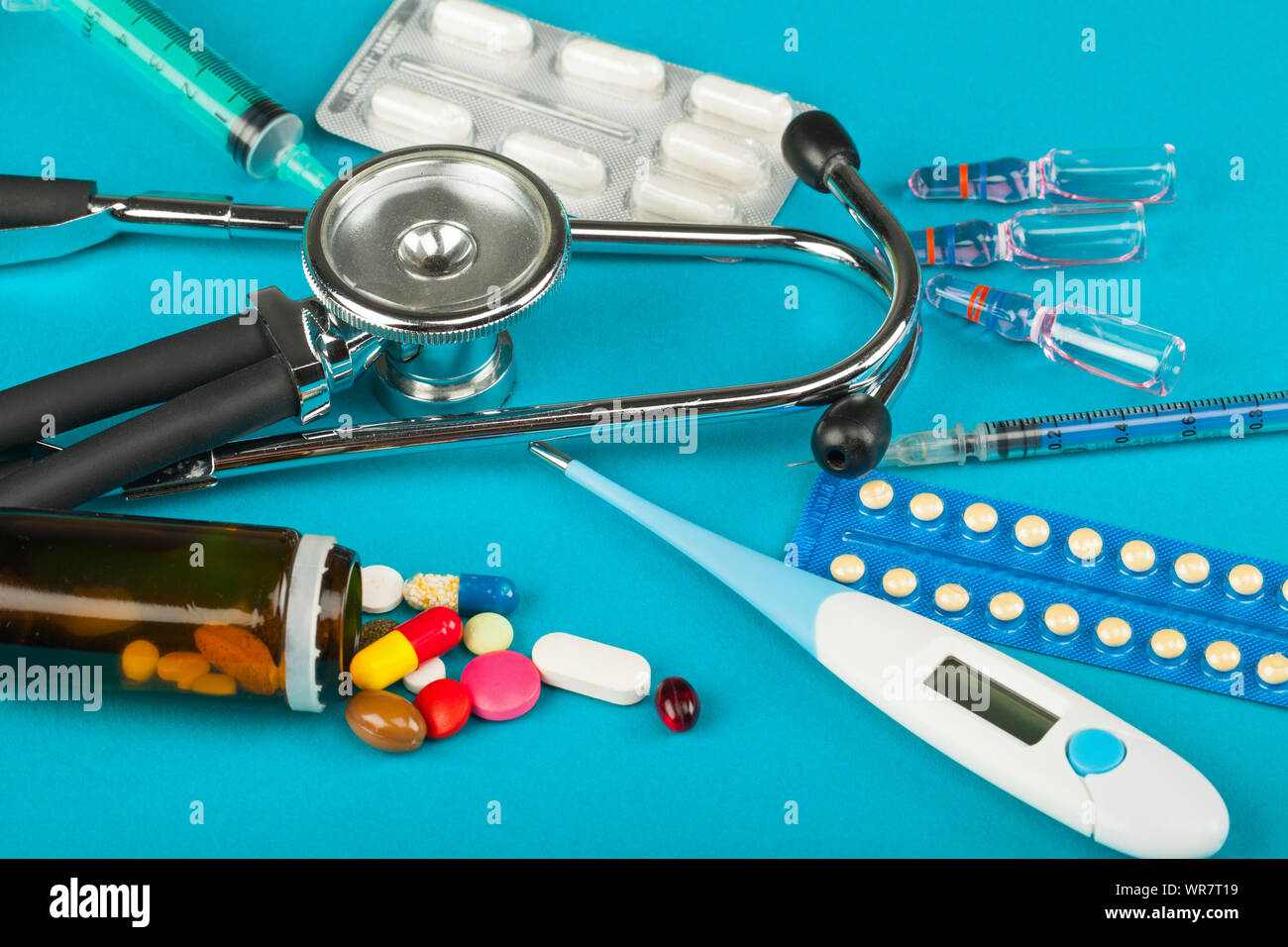 Picture of medical supplies: stethoscope, bottle of medication ...