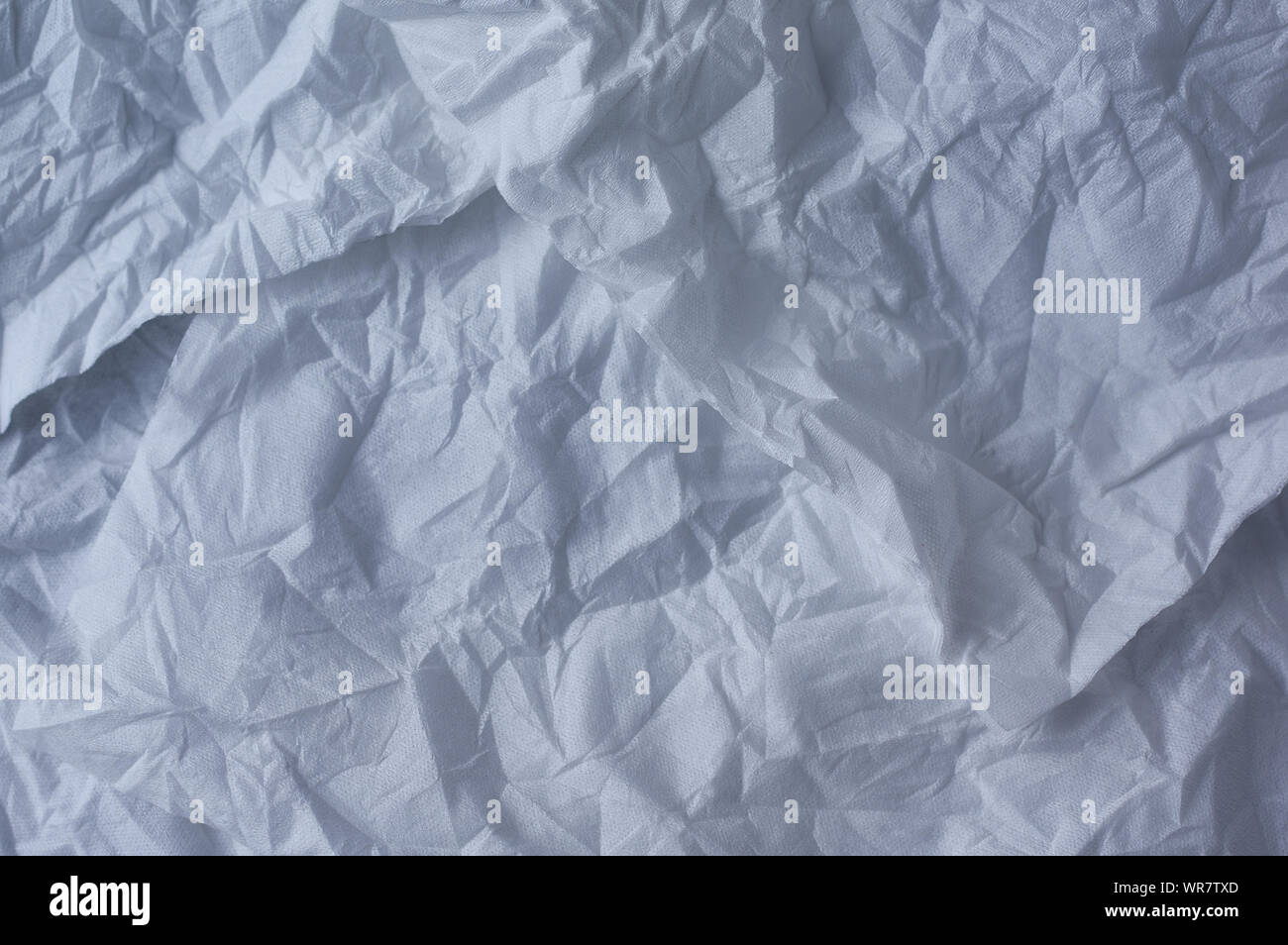 The crumpled background of the unfolded white paper Stock Photo - Alamy